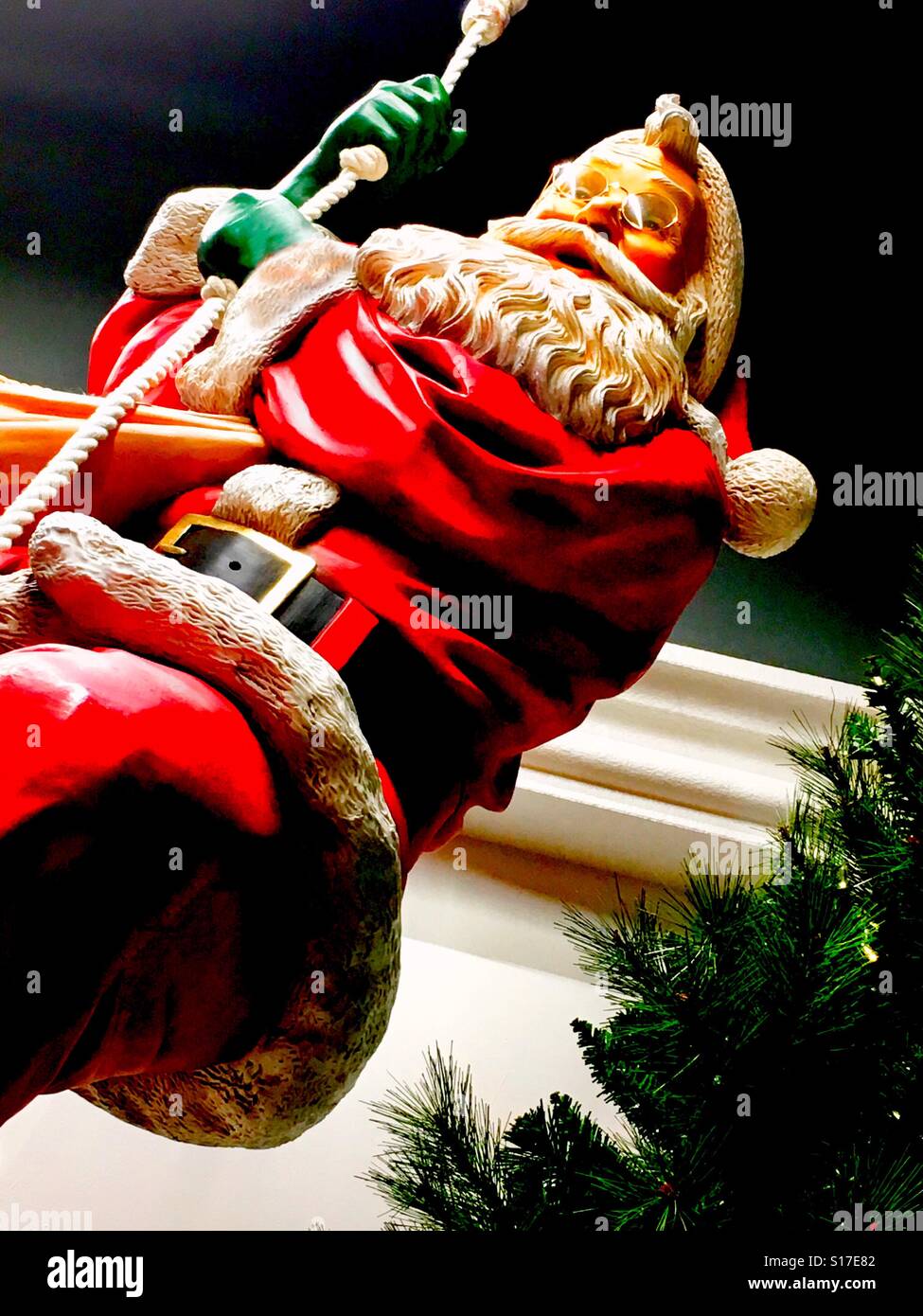 Santa Claus climbing down a rope Stock Photo - Alamy