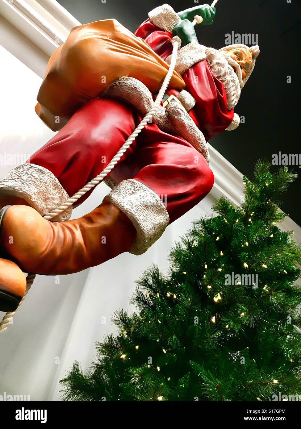Santa coming down a rope Stock Photo - Alamy