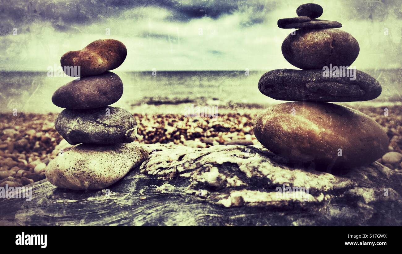 Stacked pebbles on beach Stock Photo - Alamy