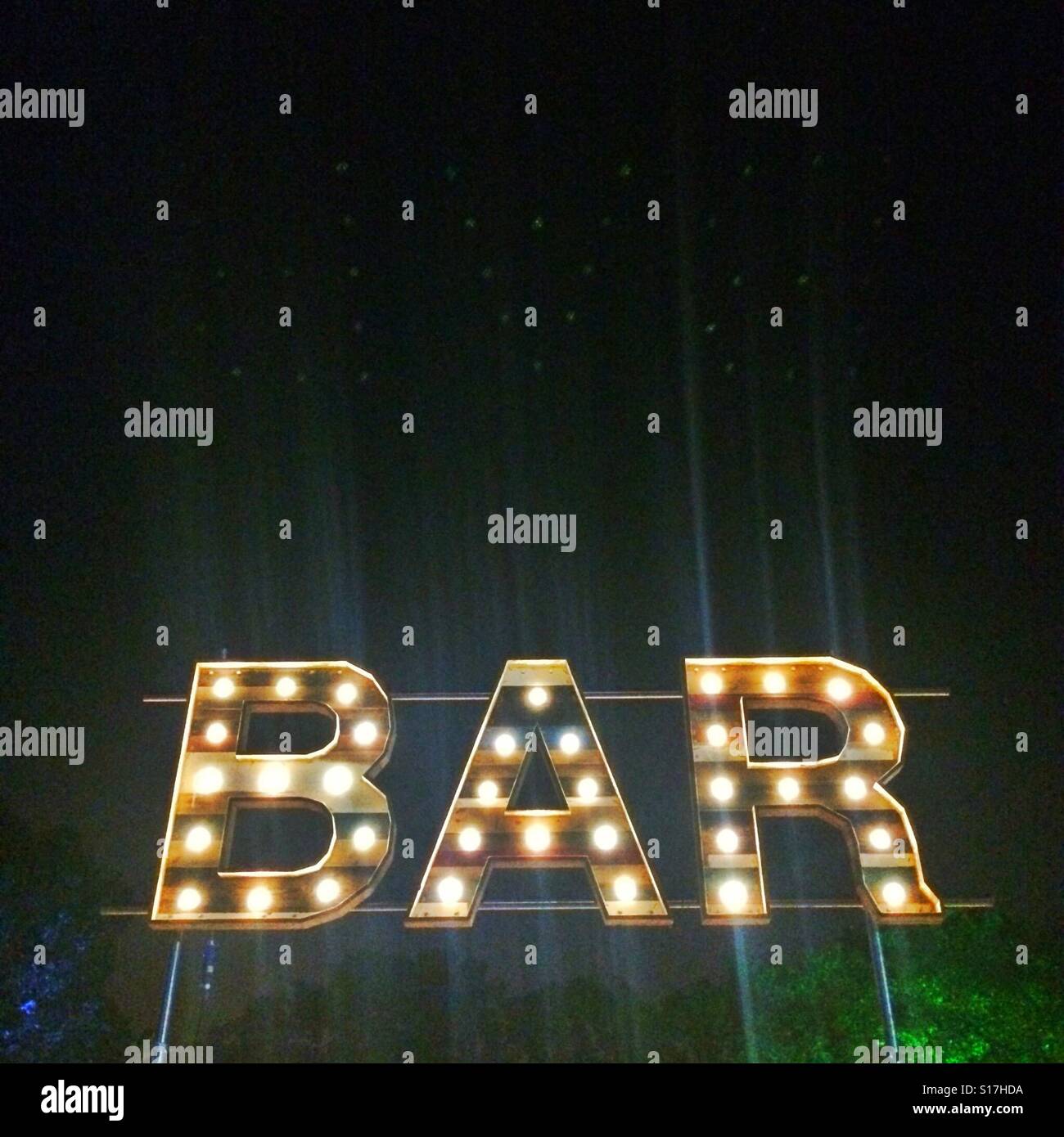 A bar sign outside against a dark sky Stock Photo - Alamy