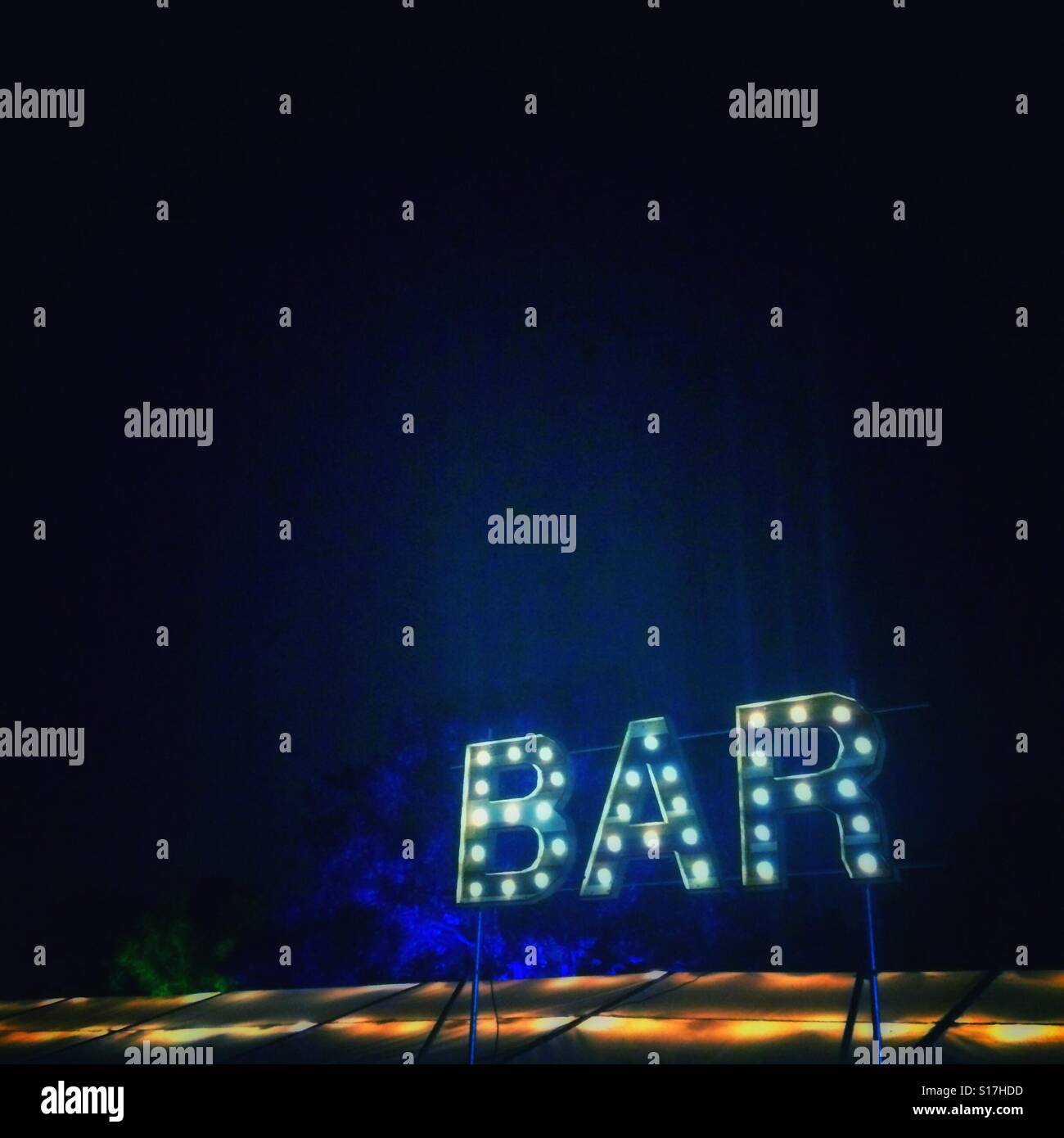 A Bar sign against a dark sky Stock Photo - Alamy