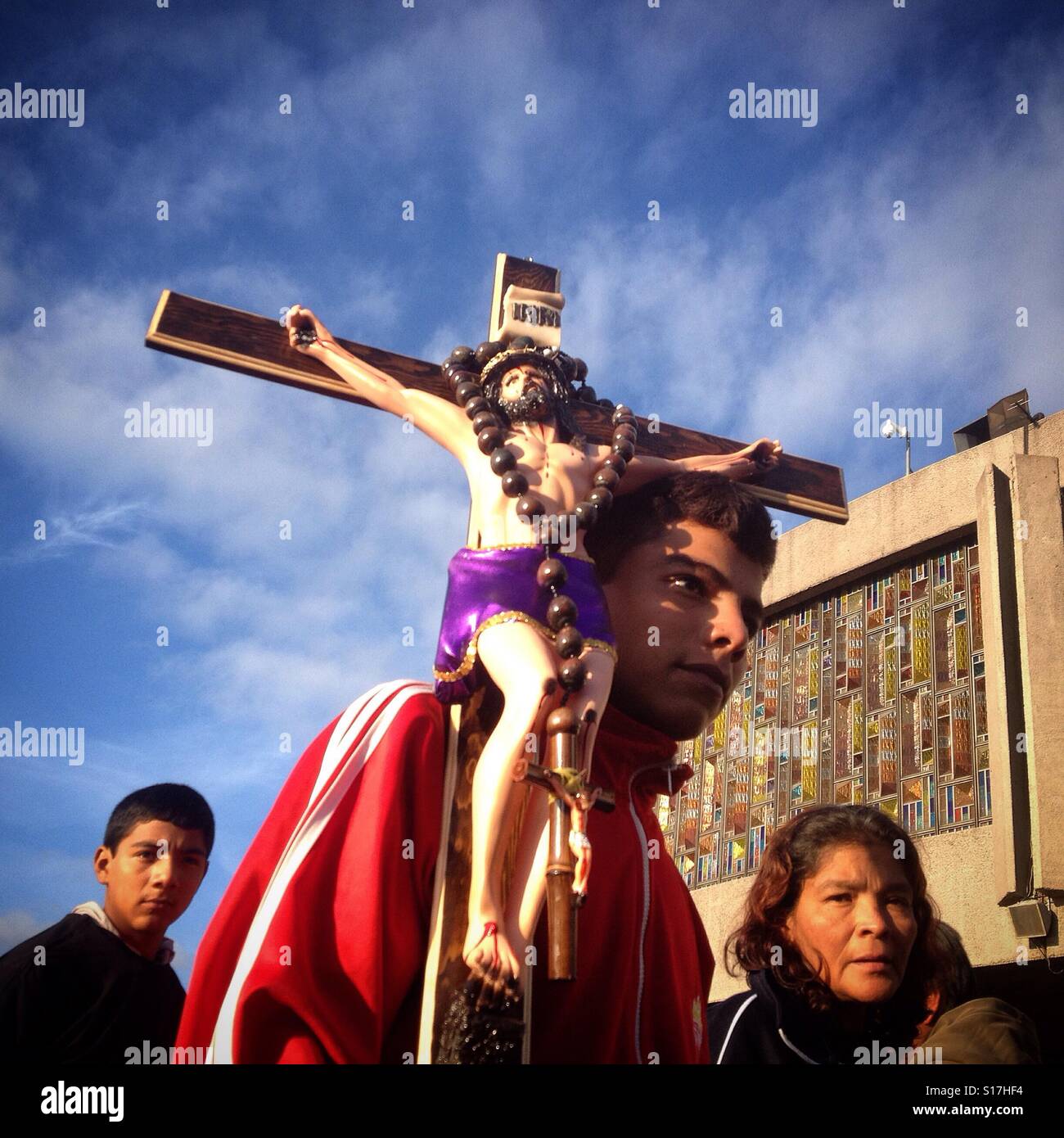 A man holds a sculpture of Jesus Christ crucified in Our Lady of ...