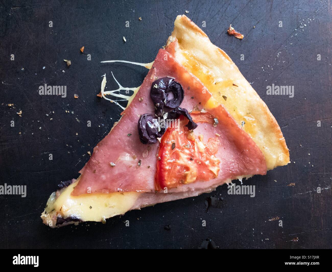 A slice of cold pizza Stock Photo - Alamy