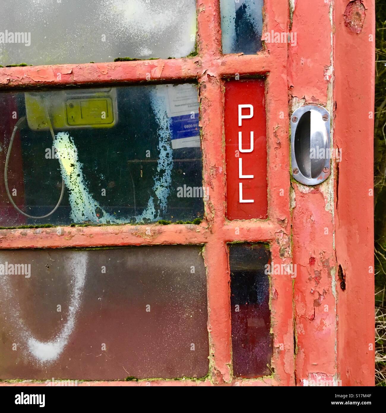 Door on an old red BT public telephone box in need of repainting Stock ...