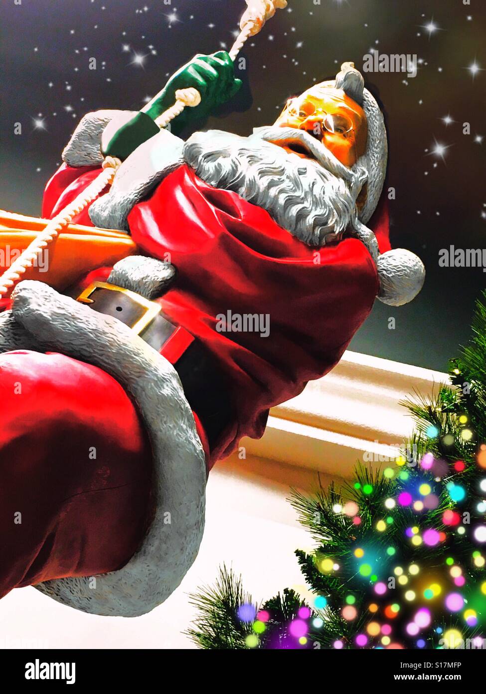 Santa climbing down a rope Stock Photo - Alamy