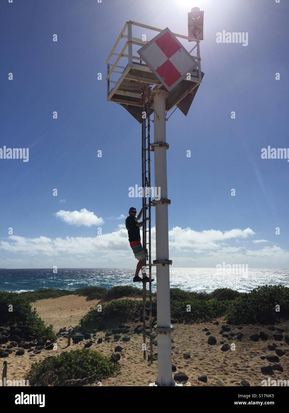 Man climbing tower Stock Photo - Alamy