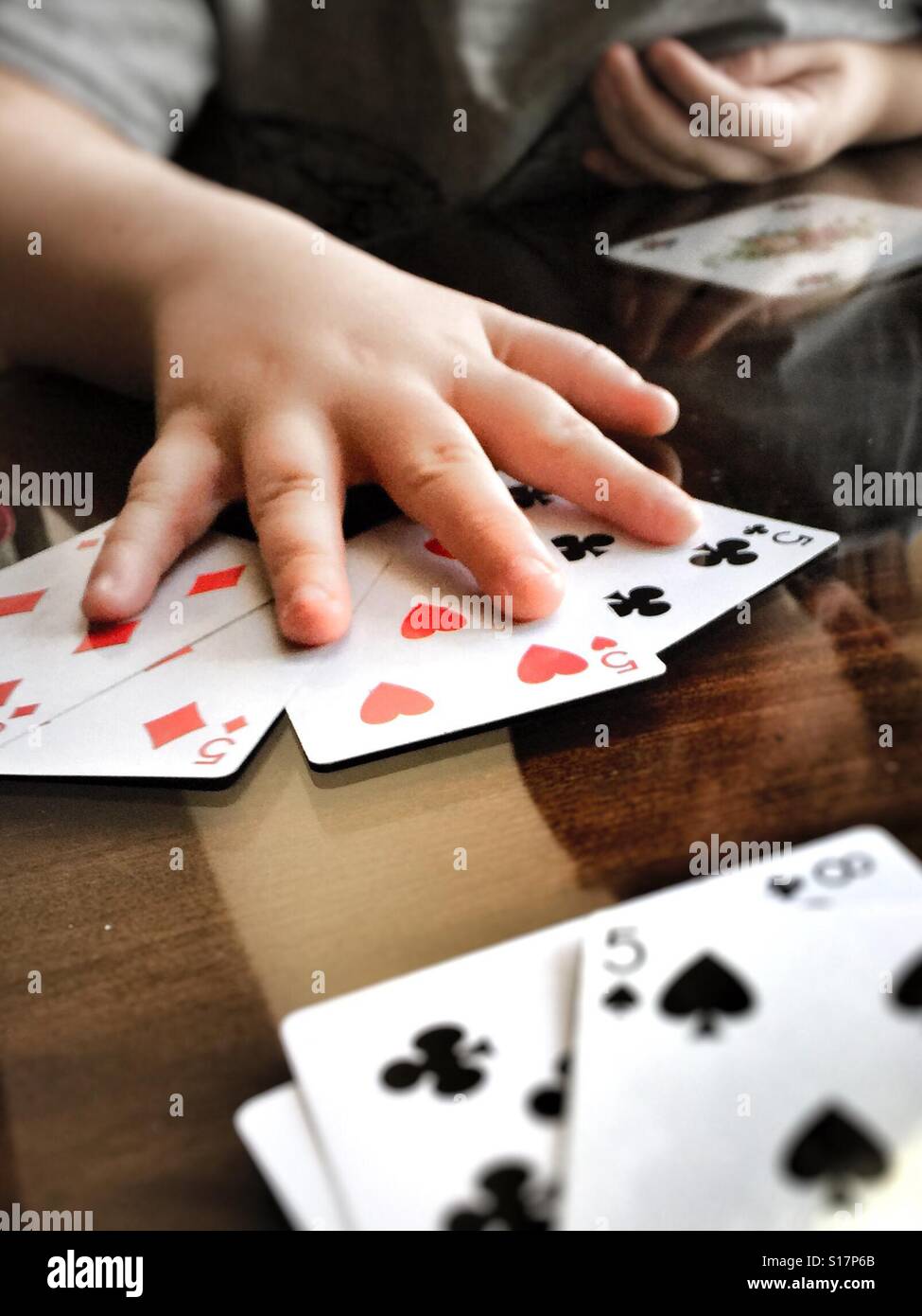 Child hand playing card hi-res stock photography and images - Alamy