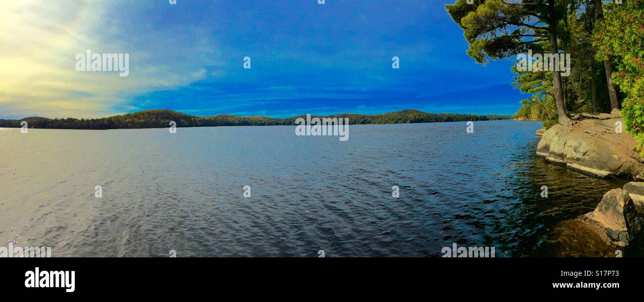 Rock Outcrop Shoreline At Forest Lakeshore Panorama Stock Photo - Alamy