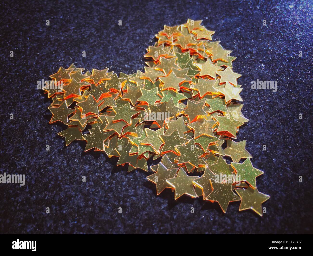 Pile of gold stars in a heart shape Stock Photo - Alamy