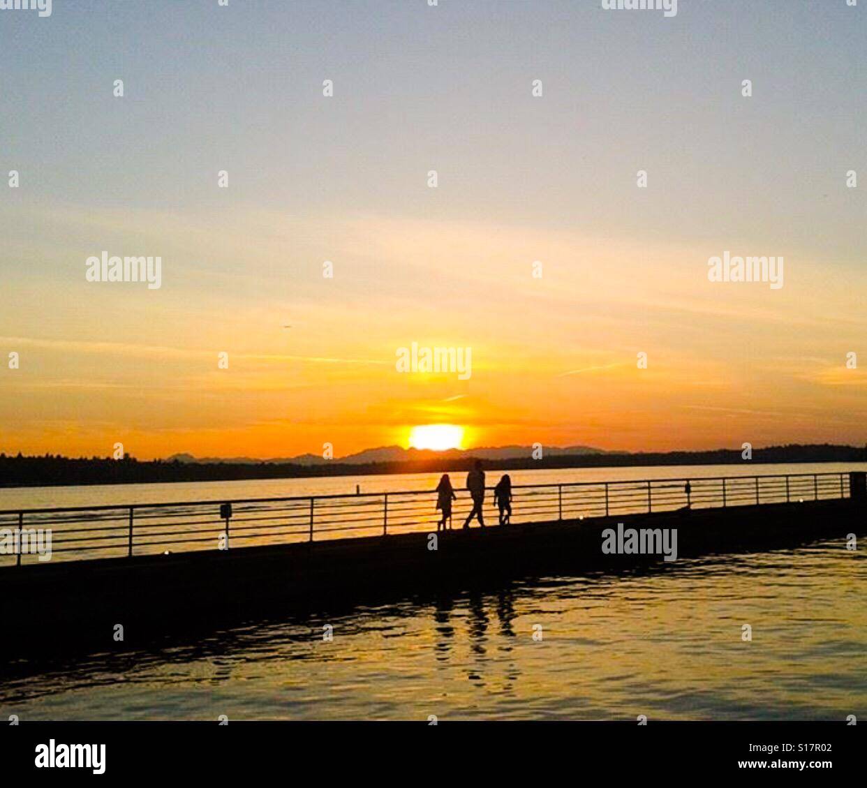 Beautiful sunset with family Stock Photo - Alamy