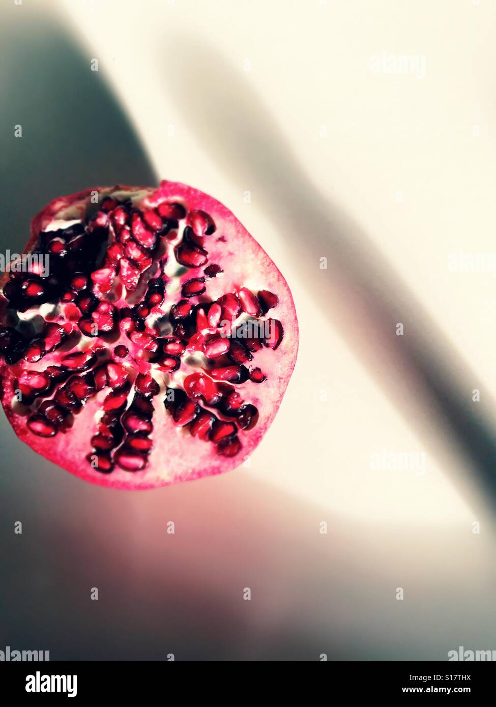 Pomegranate and shadow Stock Photo - Alamy
