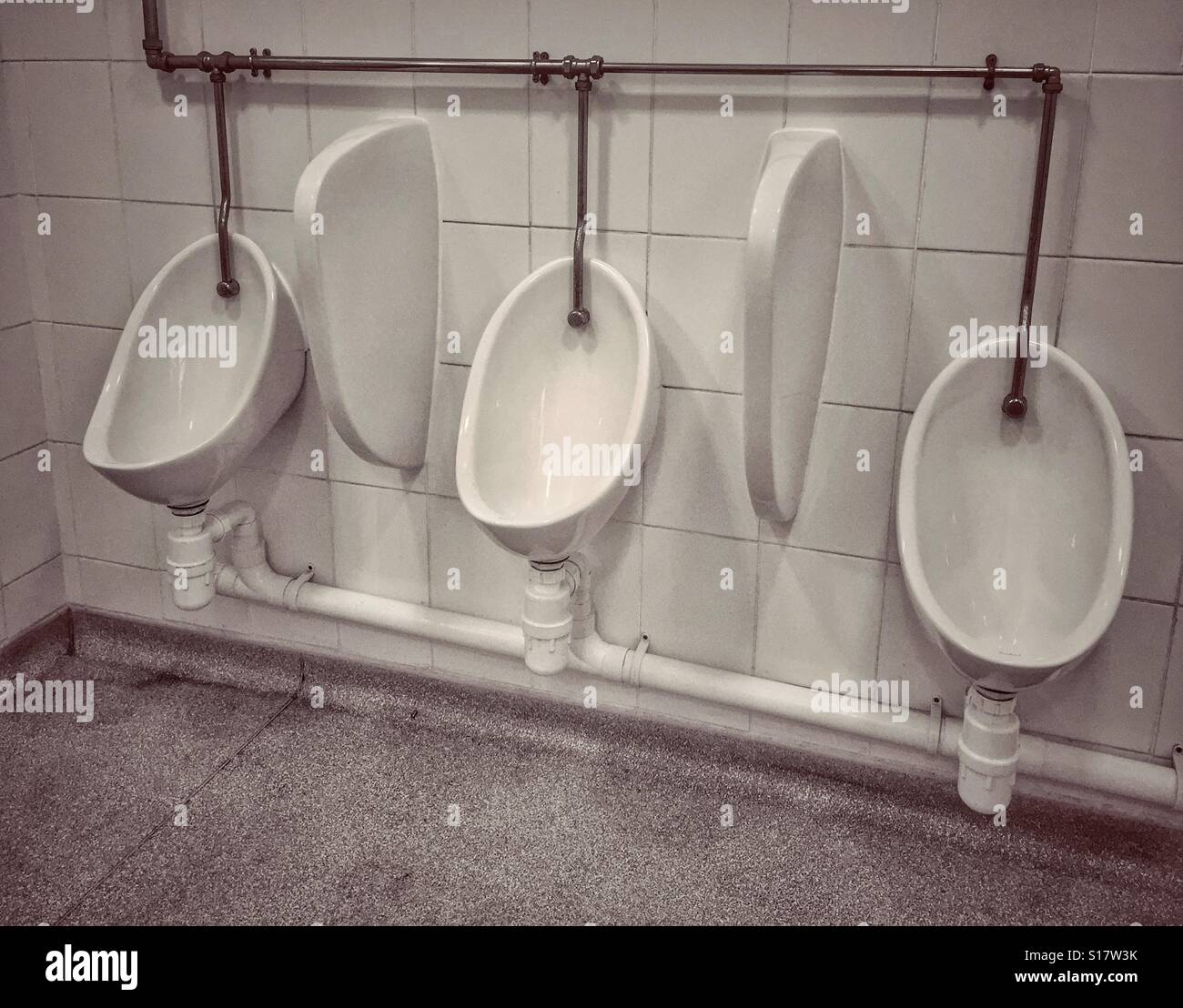 A row of three urinals in a Gent's Toilet. Thankfully they all look ...