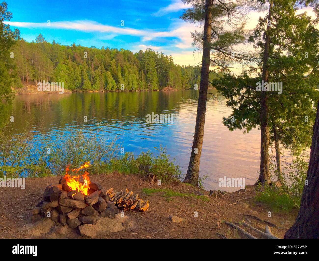 Lake Campfire With Reflections On Water At Forest Stock Photo - Alamy