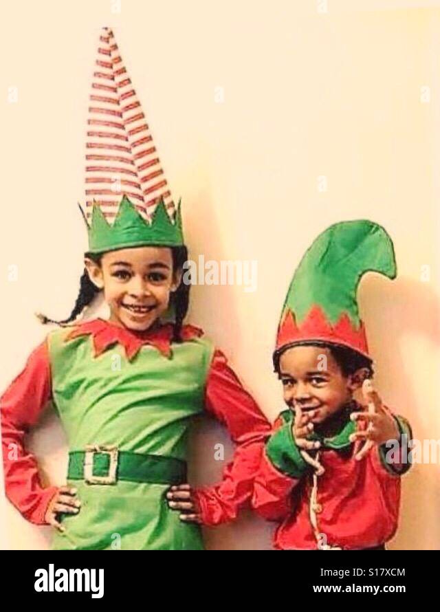 Two children in elf costumes Stock Photo - Alamy
