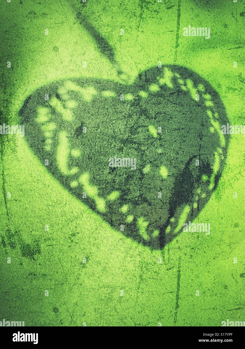 Heart shape shadow on green fabric Stock Photo - Alamy