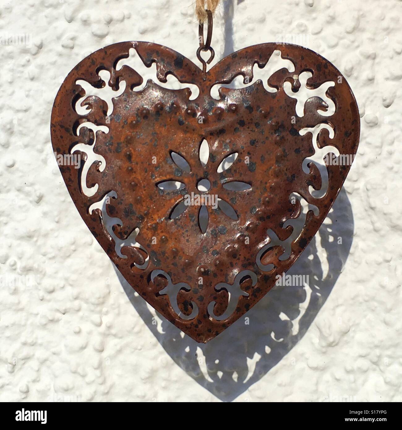 Rusty metal heart against a rustic white wall Stock Photo - Alamy