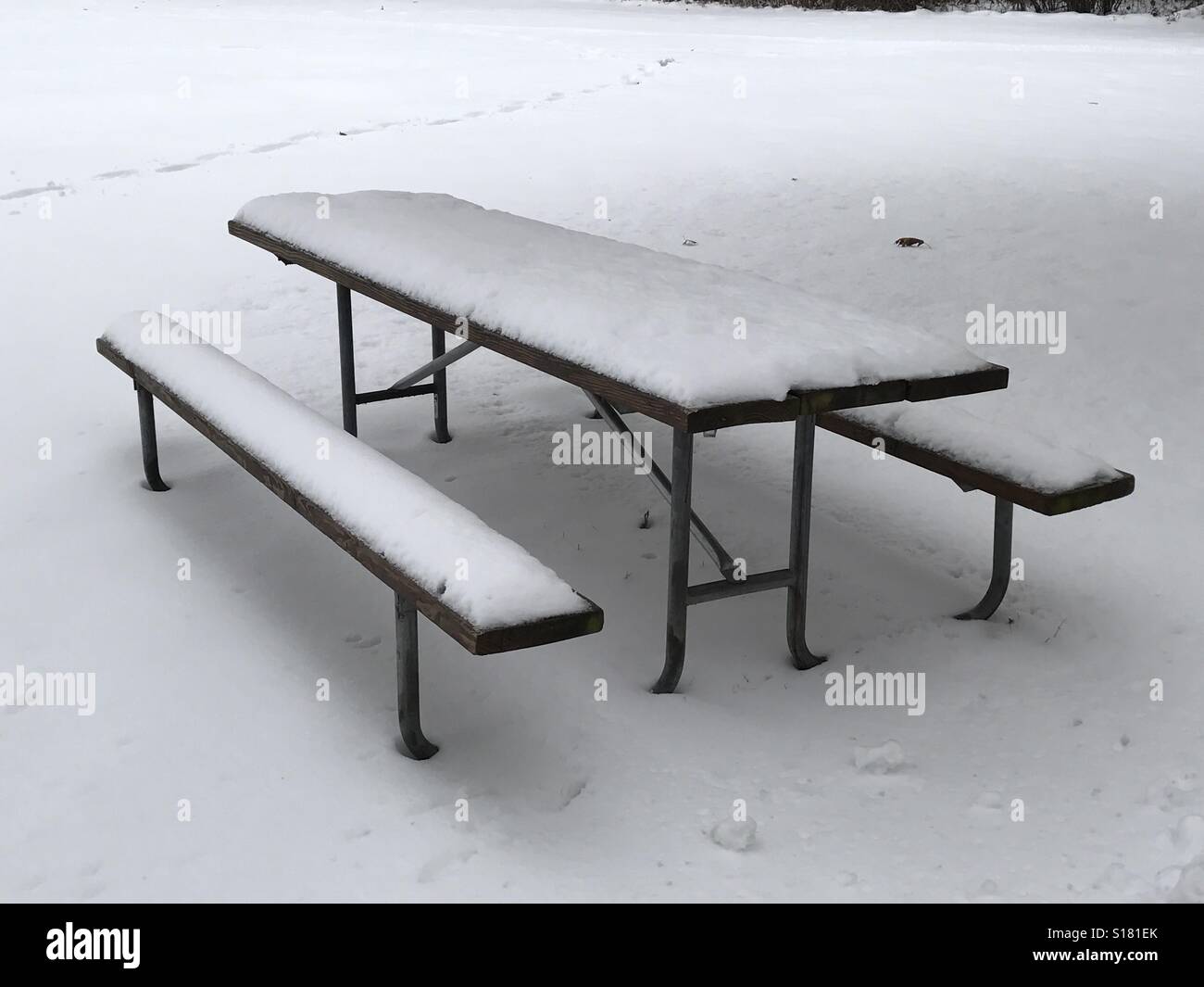 Snow covered picnic table Stock Photo - Alamy