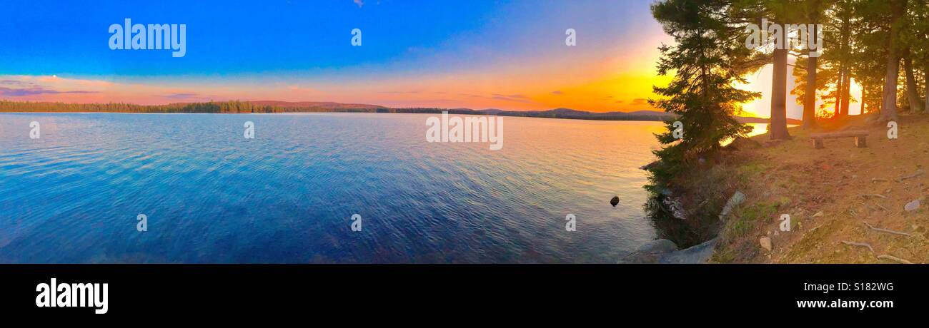 Panorama Of Sunlight Over Lake By Forest Stock Photo - Alamy