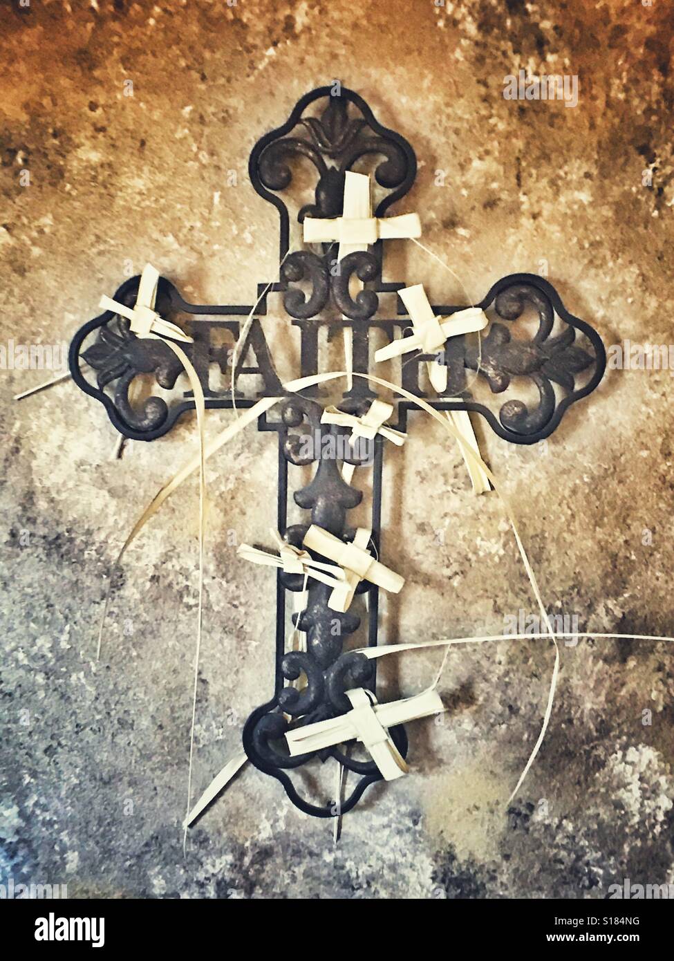 Cross hanging on the wall with the word "Faith" in it Stock Photo - Alamy