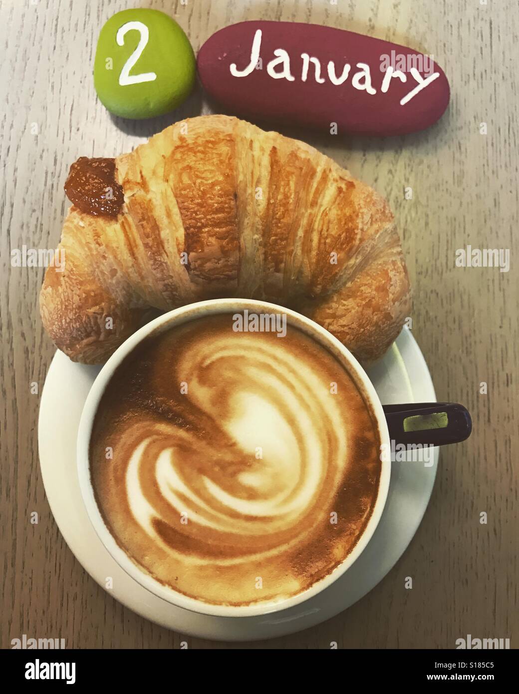 2 January, calendar date on stones with cappuccino and croissant Stock ...