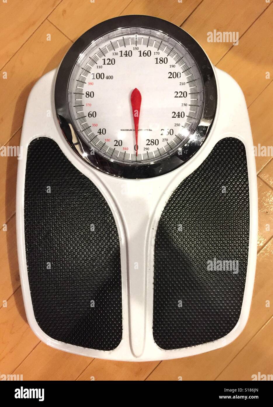 A scale on a wooden floor Stock Photo - Alamy
