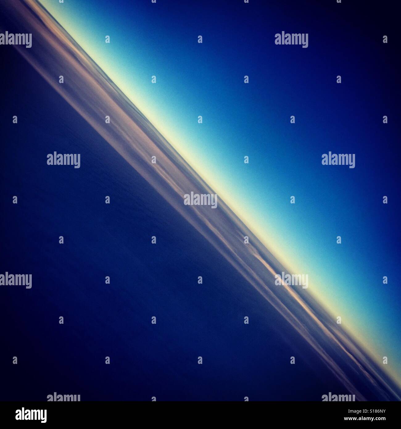 Sunset skewed horizon,airplane window view Stock Photo - Alamy