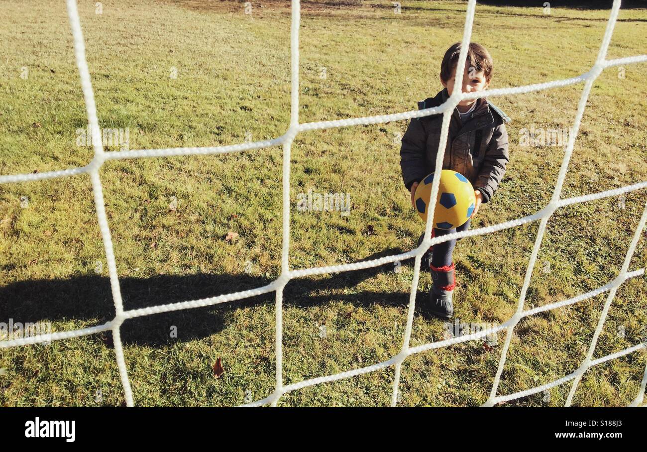 Boy playing football in match hi-res stock photography and images - Alamy