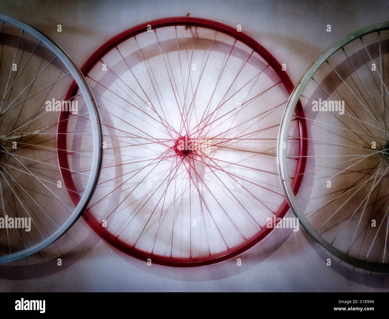 Bicycle wheels on a wall Stock Photo - Alamy