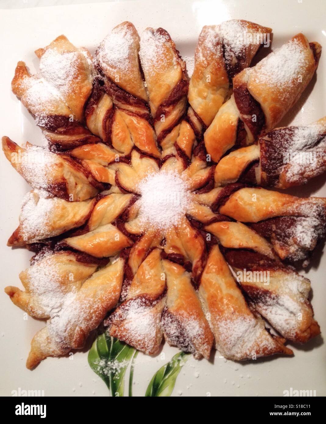 Flower shaped puff pastry filled with chocolate Stock Photo - Alamy