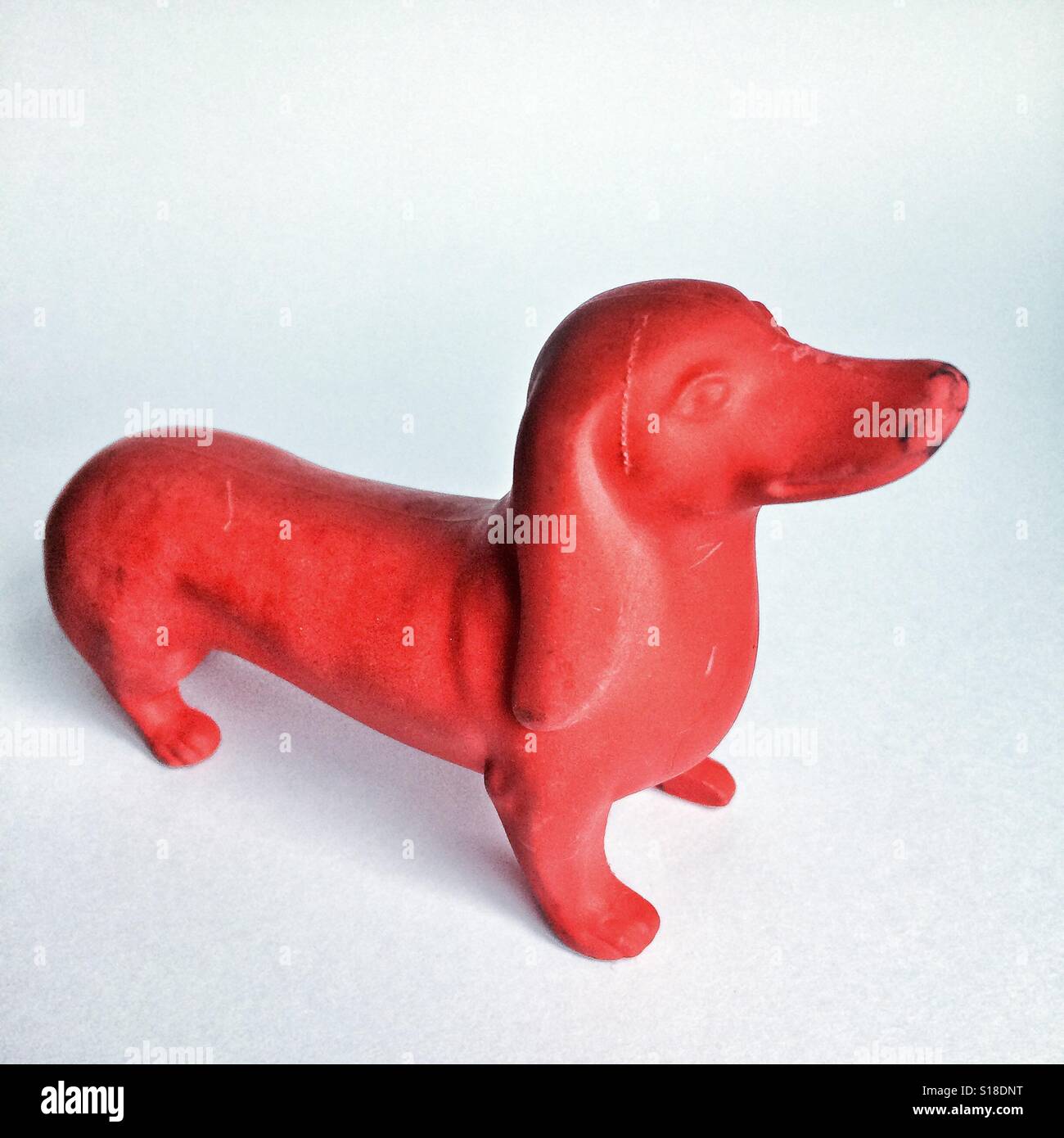 A red dog shaped rubber Stock Photo - Alamy