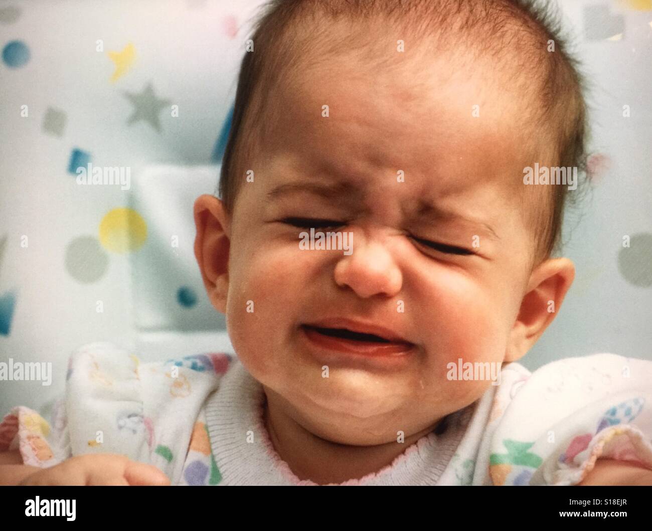 A baby girl crying angrily Stock Photo - Alamy