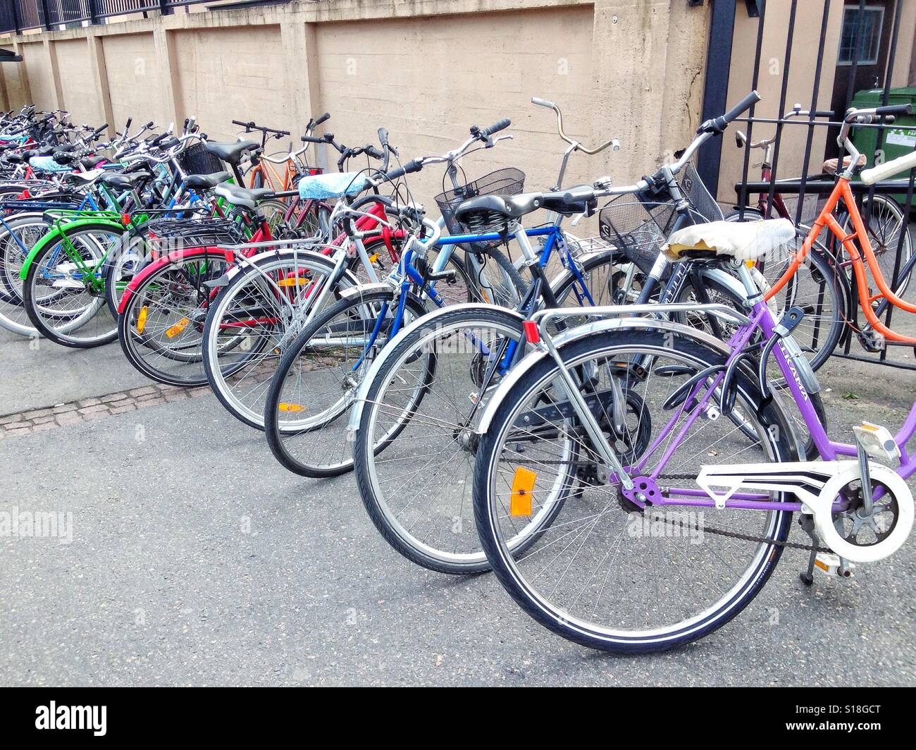 Row of bicycles on a parking lot Stock Photo - Alamy
