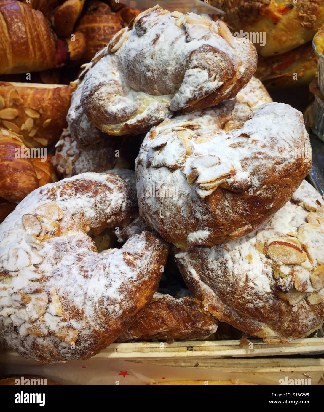 Almond croissants in bakery shop window USA Stock Photo - Alamy