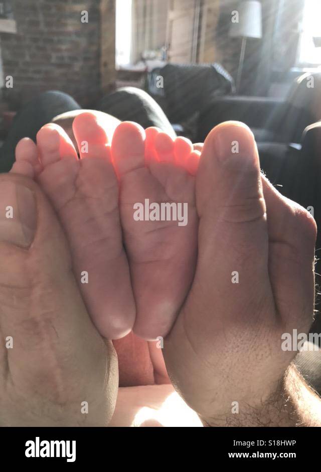 Baby holding feet hi-res stock photography and images - Alamy