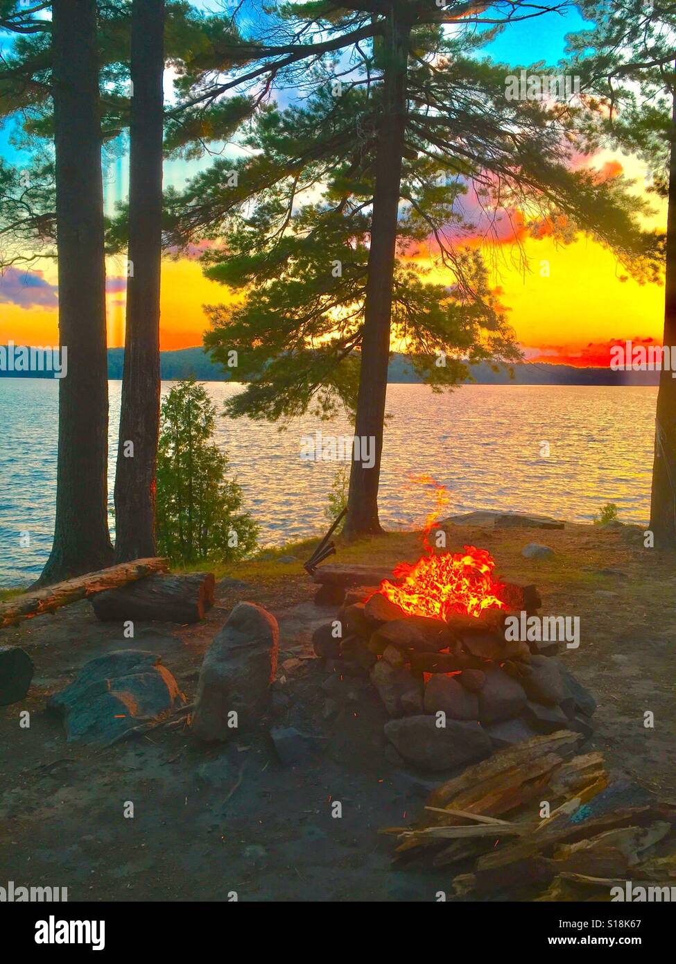 Sunlight And Campfire Lake View Stock Photo - Alamy