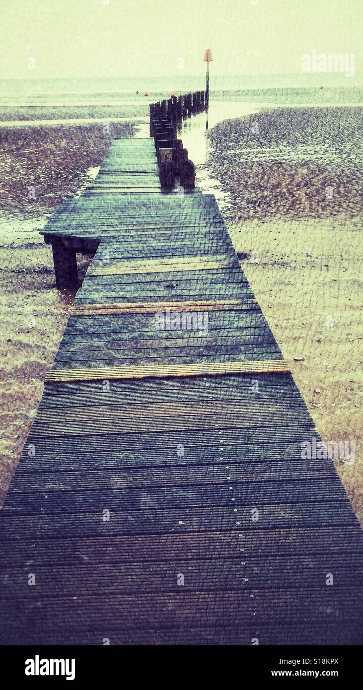 Board walk jetty at low tide Stock Photo - Alamy