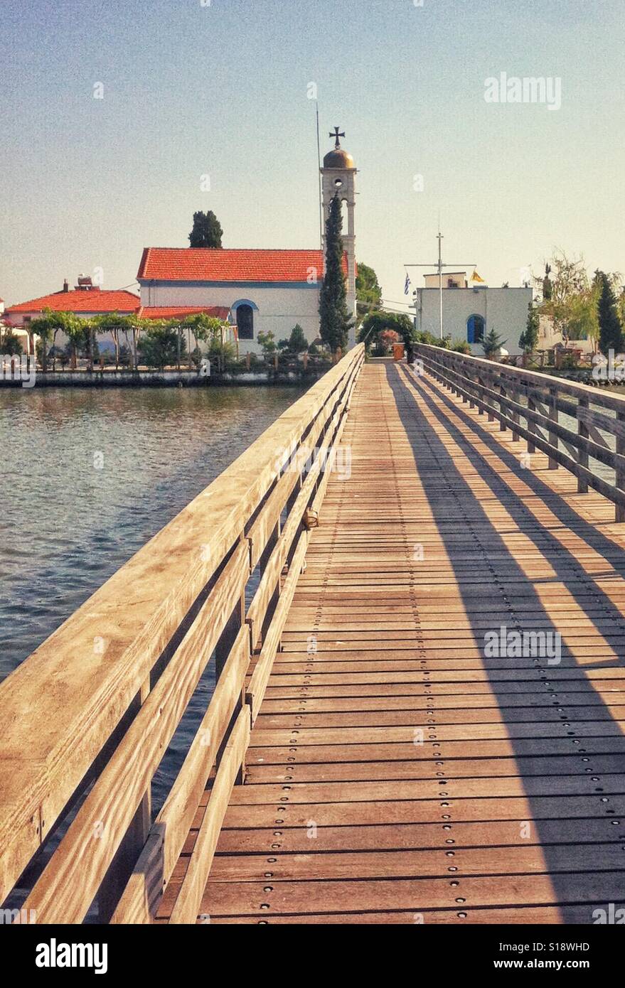 Wooden bridge leading to an old church Stock Photo - Alamy