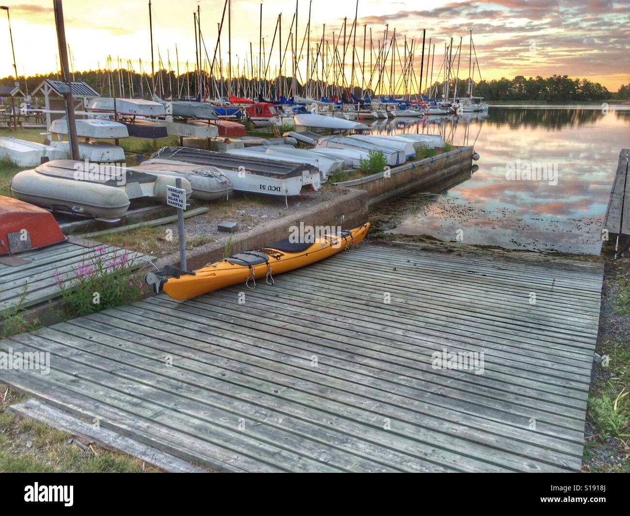 Kayak in harbour with other boats Stock Photo - Alamy