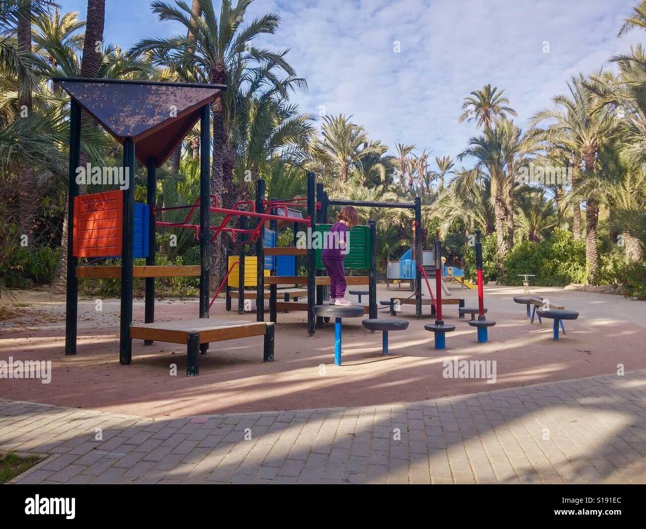 Little girl on the playground. Tropical park in Alicante. Spain Stock ...