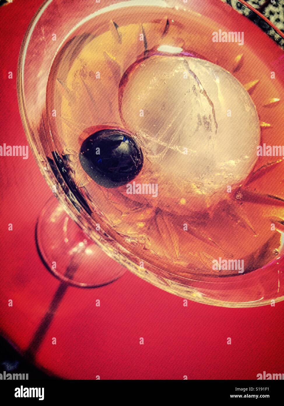 Manhattan cocktail with ice sphere and cherry Stock Photo - Alamy