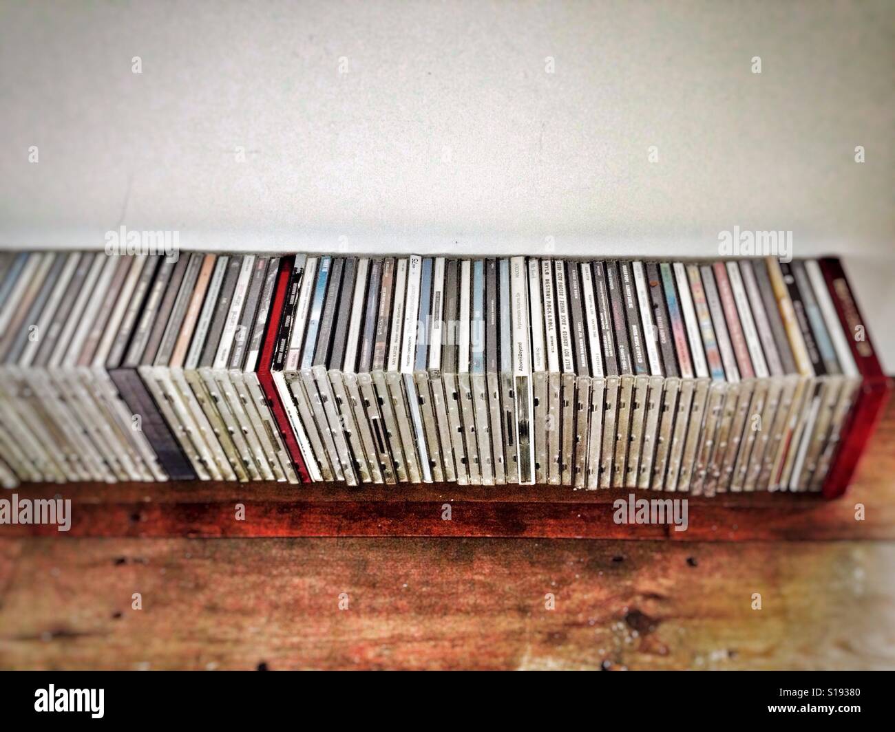Compact discs on wooden shelf Stock Photo - Alamy