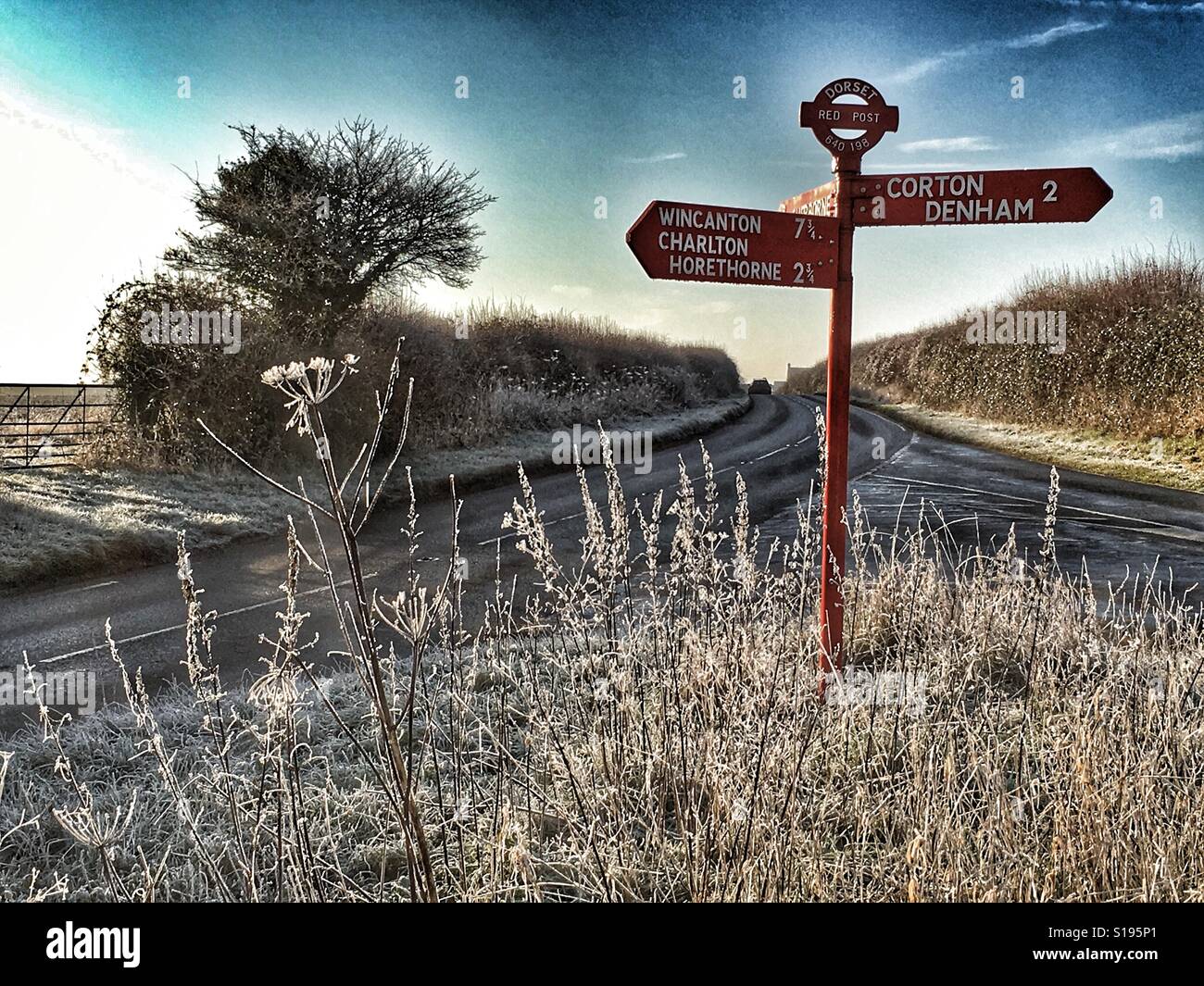Dorset red signpost, in winter. Early morning ice and frost, looking ...
