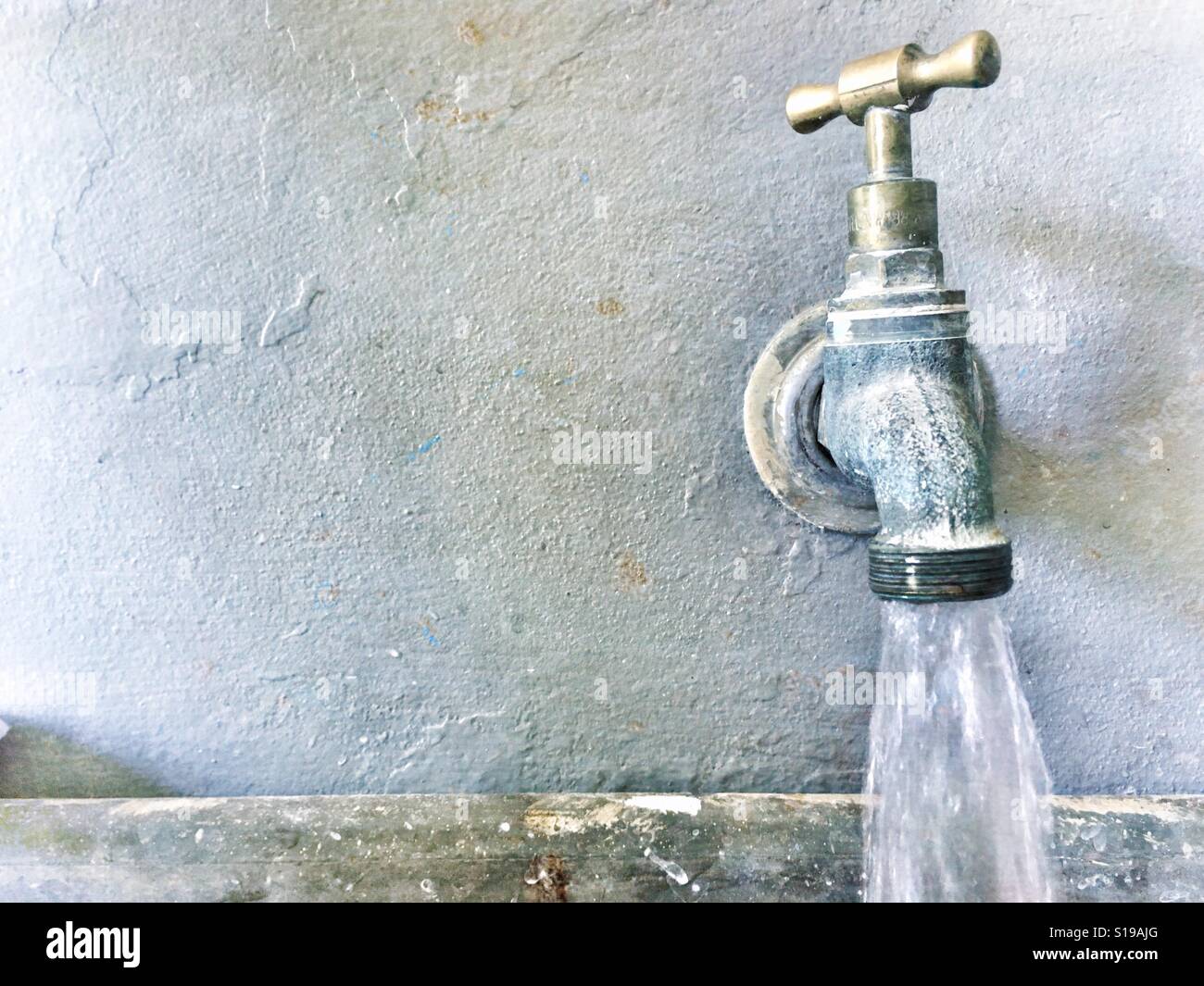 Open faucet with running water Stock Photo - Alamy