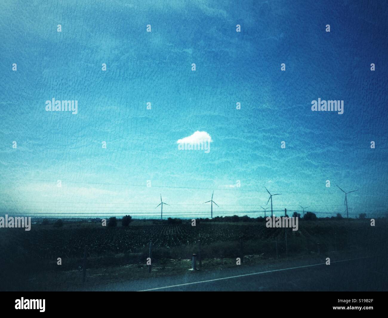 Lone cloud over wind turbines Stock Photo - Alamy