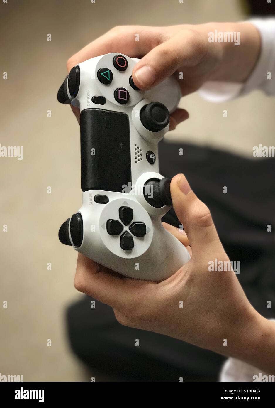 Hands holding playstation controller hi-res stock photography and ...