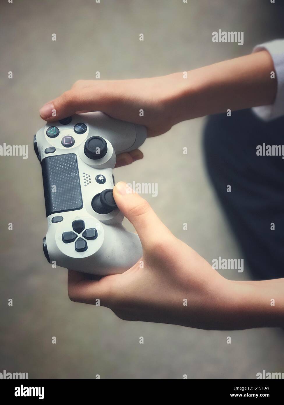 A boy holding a PlayStation controller Stock Photo - Alamy