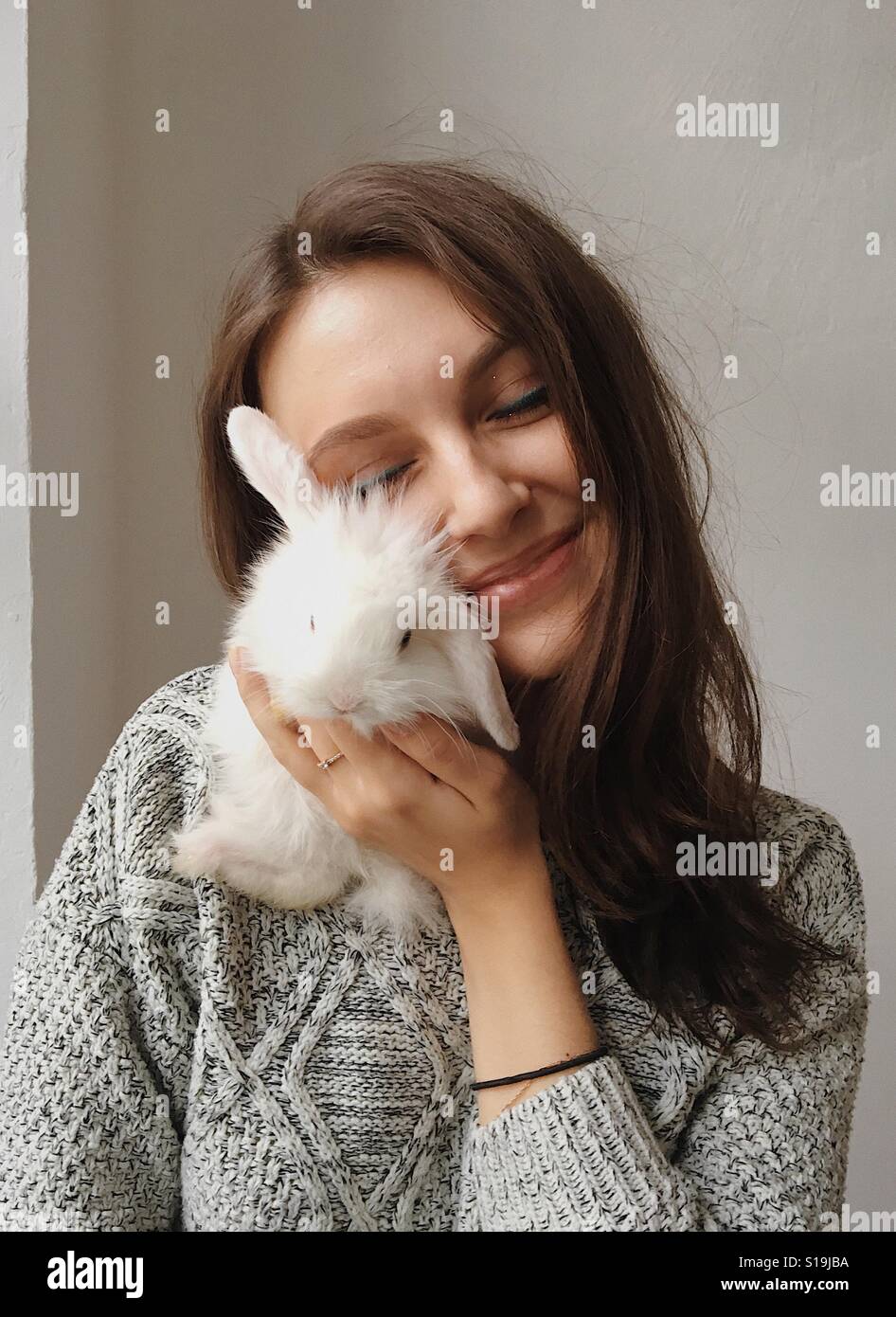 Woman holding rabbit hi-res stock photography and images - Alamy