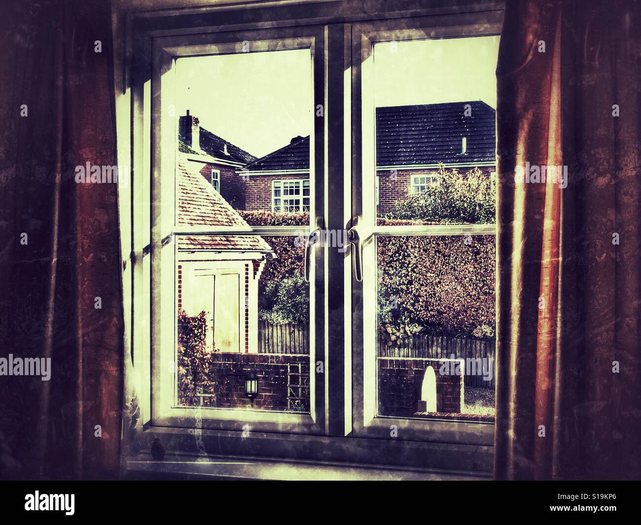 Inside looking out to neighbourhood house Stock Photo - Alamy