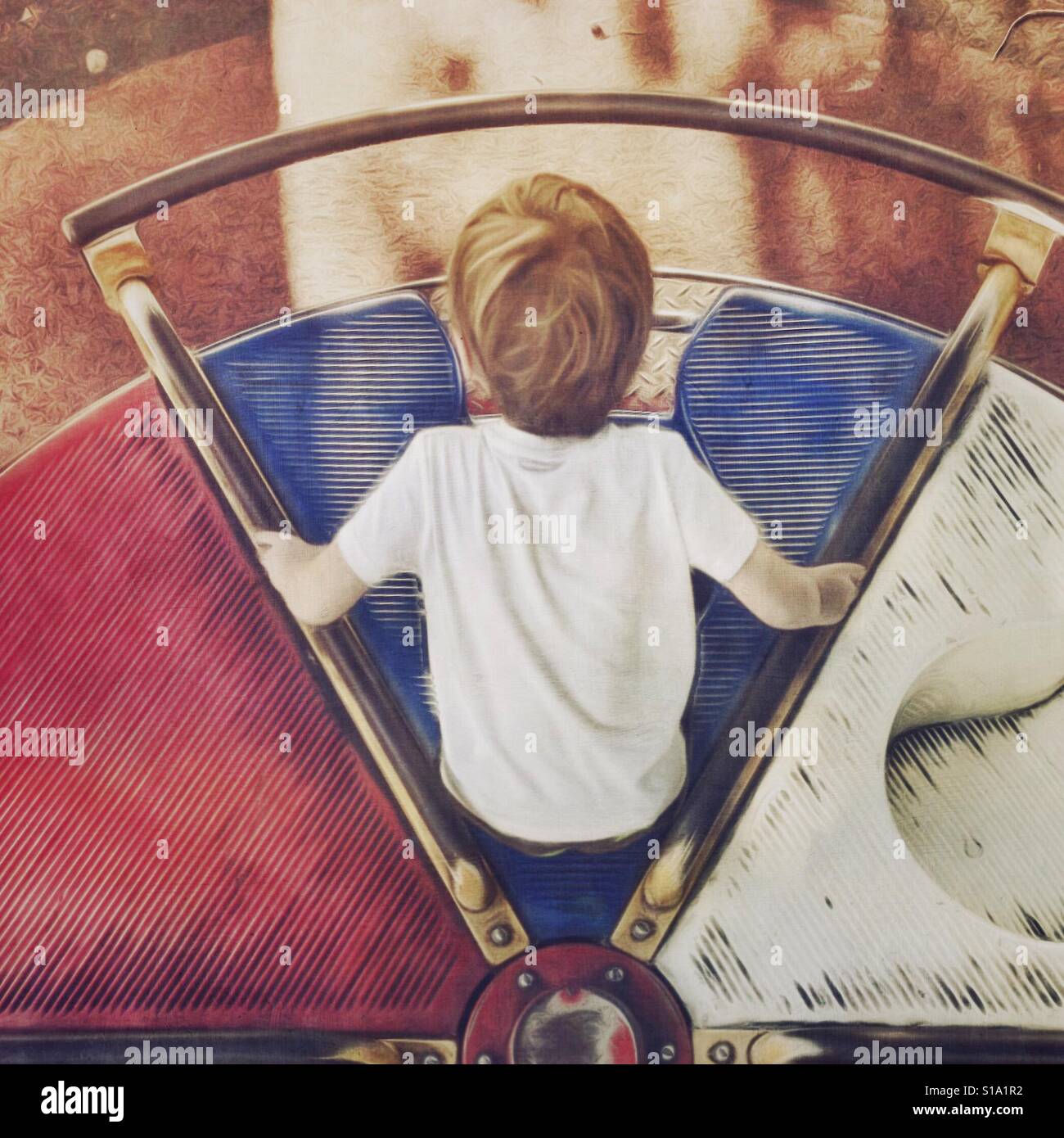 Overhead of child on roundabout Stock Photo - Alamy