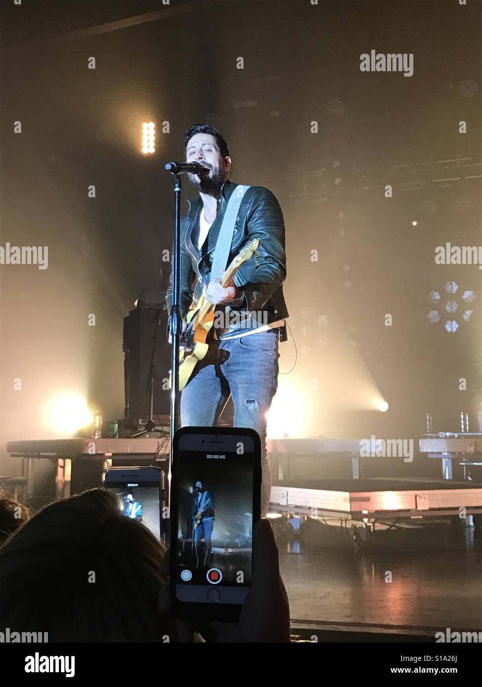 Old Dominion lead singer, Matthew Ramsey, performs in front of a crowd ...